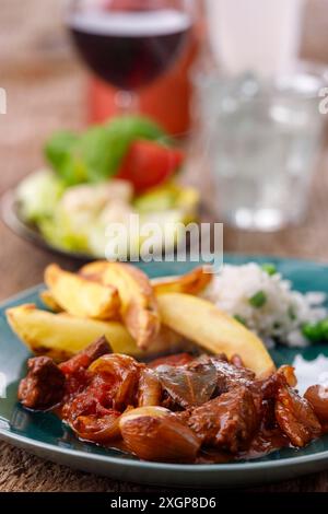 greek stifado meat stew with fries Stock Photo - Alamy