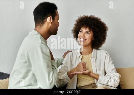 An African American couple communicates using sign language while ...