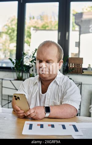 A man with inclusivity works at a desk in a modern office Stock Photo ...