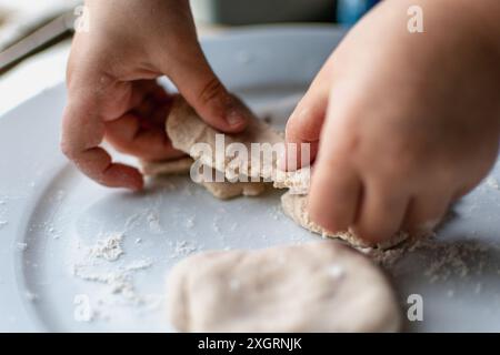Child having fun modeling salt dough, authentic activity, fine motor ...