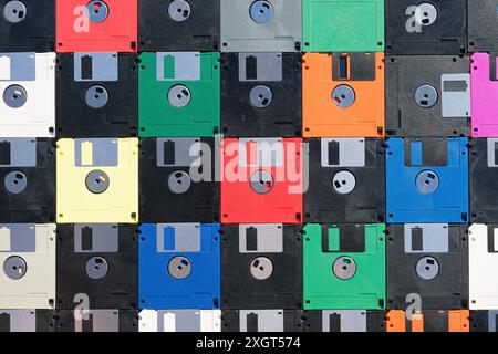 Vintage colored floppy disks background. Old technologies. Selective ...