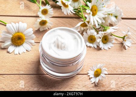 Natural skin care product. Open jar of moisturizing cream on green ...