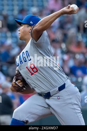 Chicago Cubs pitcher Shota Imanaga, of Japan, tosses a baseball into a bucket during fielding ...