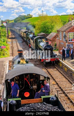 Three preserved ex-GWR steam locos 7828, 9351 & 6990 passing at Williton station at the West ...