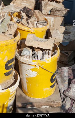 Yellow buckets filled with building rubble, Germany Stock Photo - Alamy