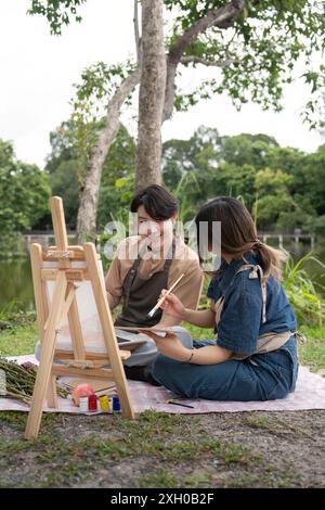 Romantic Picnic Couple Drawing Outdoors by the Lake. Creative Art ...