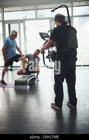 Photographer, camera and shooting with stabilizing equipment on set for ...