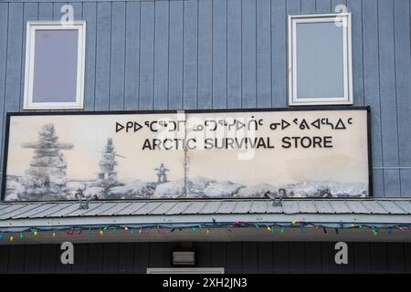 Bilingual Arctic Survival Store sign in English and Inuktitut on Nipisa ...