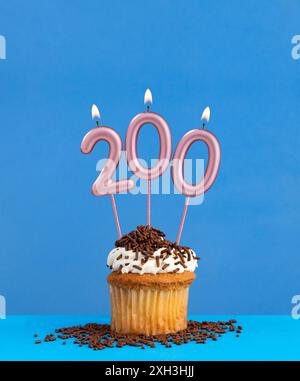 Number 200 birthday candle - Cupcake on black background with out of ...