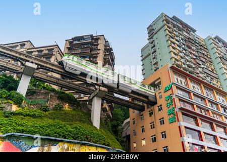 Chongqing, China - 07 May 2024: Train going through a building at ...