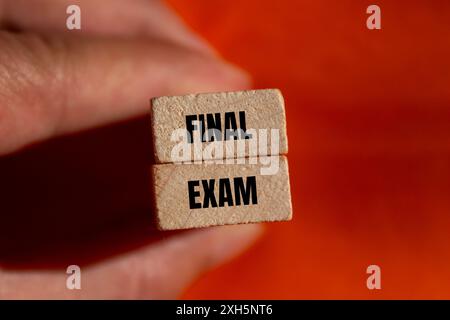 Final exam message written on ripped torn yellow paper piece with ...