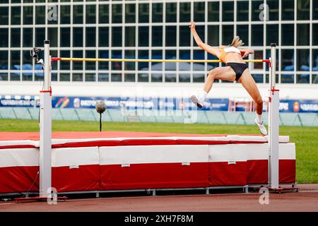 successful attempt high jump female athlete at athletics competition ...