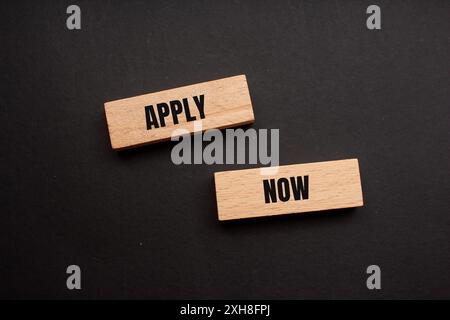 Apply now message written on ripped paper with color background ...