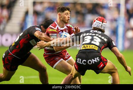 St Helens' Harry Robertson (centre) is tackled by Leigh Leopards' Isaac ...