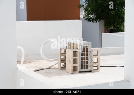 Air conditioner compressors attached to bricks to protect them from the ...