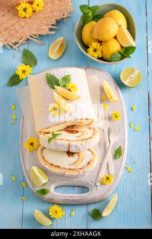 Homemade mango swiss roulade served as summer dessert. Swiss roll with ...