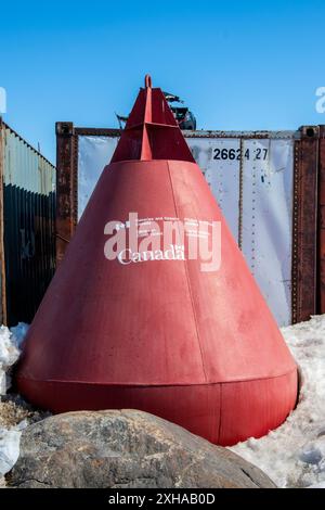 Red starboard marker buoy on the beach on Frobisher Bay in Iqaluit ...