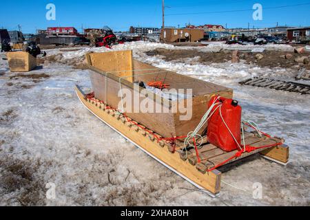 Inuit qamutiik wooden sleds stored on the beach on Frobisher Bay in ...