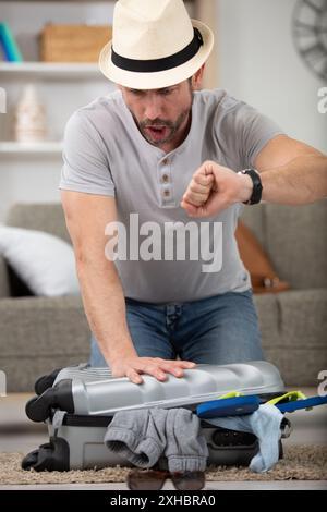 man packing suitcase is running late Stock Photo - Alamy