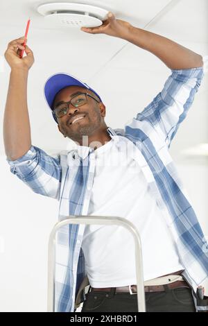 Man fitting an air vent Stock Photo - Alamy