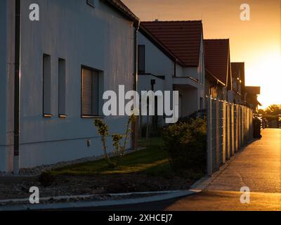 Sunrise at suburban street in a small village Stock Photo - Alamy