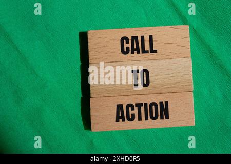 Call to action words written on wooden blocks with pink background ...