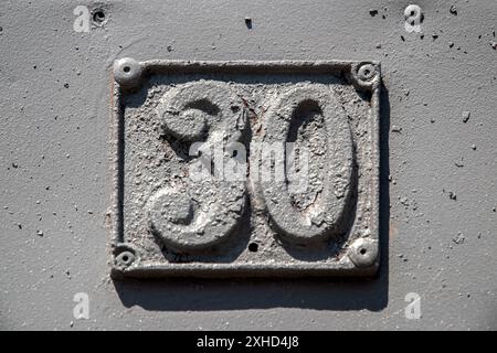 Old retro weathered cast iron plate with number 33 closeup Stock Photo ...