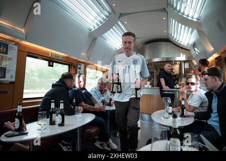 England fans and family members make their way to Berlin on the train ...