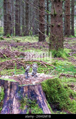 Two figures stand in a tranquil landscape, one partially submerged in ...