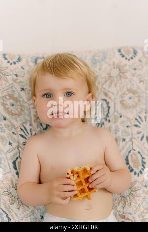 Toddler eating waffle Stock Photo - Alamy