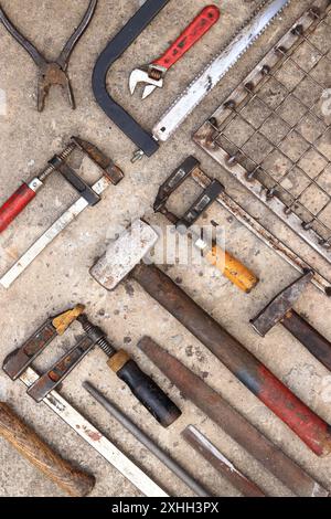 Old construction tools laid out on a concrete background, top view ...