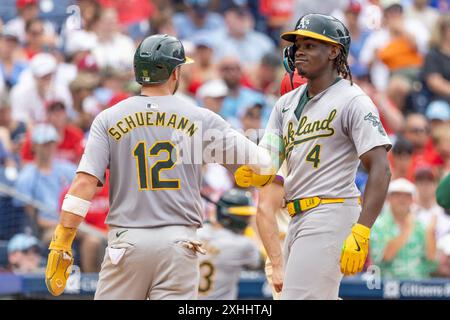 Athletics' Max Schuemann (12), Lawrence Butler (4) and Denzel Clarke (1 ...