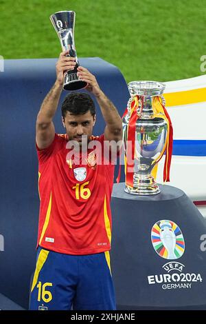 Spain's Rodri with the Player of the Tournament trophy after winning ...