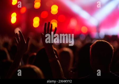 Fans raise hands at open air rock concert Stock Photo - Alamy