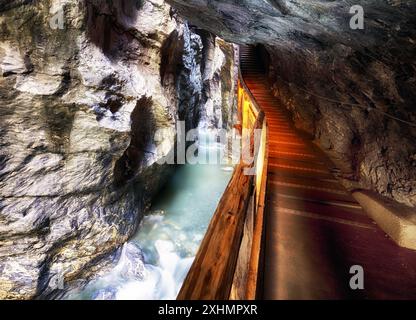 Climb a steep wooden staircase under the rocks stairs along the ...