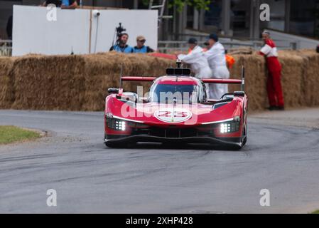 Ferrari 499P Modificata driving up the hill climb track at the Goodwood ...