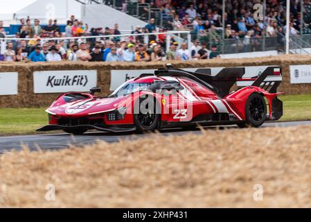 Ferrari 499P Modificata driving up the hill climb track at the Goodwood ...