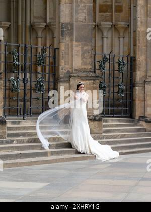 A bride poses for pre-wedding photo at the Prague Cathedral Golden Gate ...