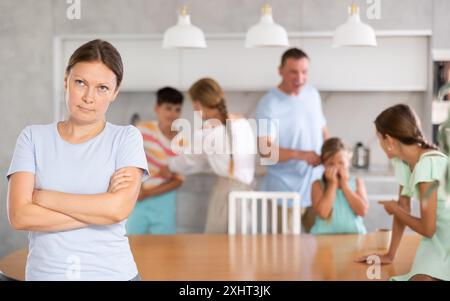 Irritated mom is tired of noise and screams of the children at home ...