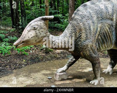 Realistic figure of an Zaurolof dinosaur inforest park in Kazimierz Sosnowiec. Prehistoric ...