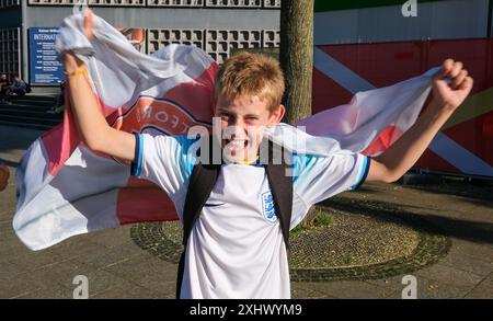 Young England football fan in Berlin draped in England flag cheering ...