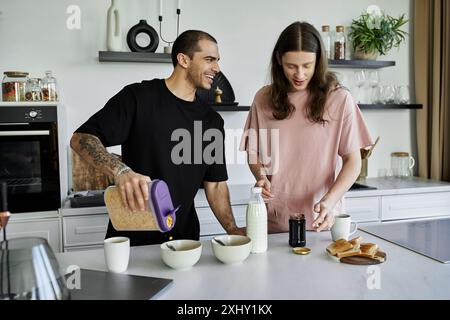 A young gay couple prepares breakfast together in a modern kitchen ...