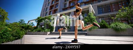 young sporty woman jogging across the bridge at sunny morning in the ...
