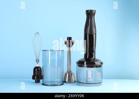 Hand blender kit on light blue background, flat lay. Space for text ...