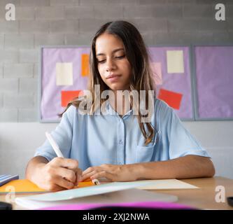 Student in the classroom at school writing on the chalkboard. Boy ...