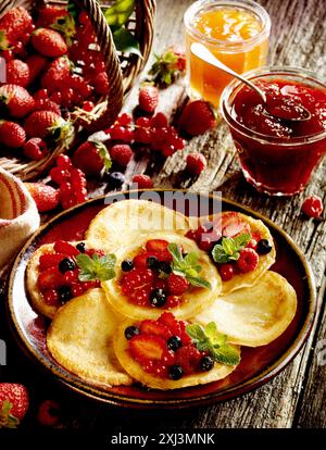 Jar of wild strawberry jam with spoon on white background Stock Photo ...