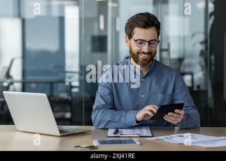 financial adviser working with calculator & computer at office ...