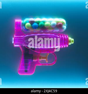 Design gun filled with sweets Stock Photo - Alamy
