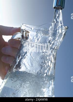 Filling a jug of water under the tap Stock Photo - Alamy