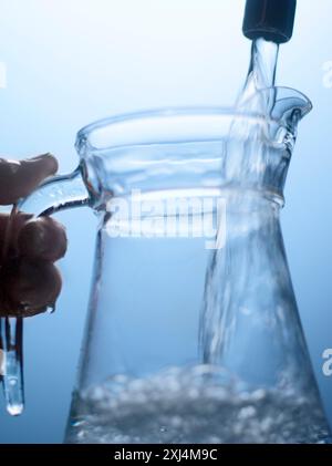 Filling a jug of water under the tap Stock Photo - Alamy